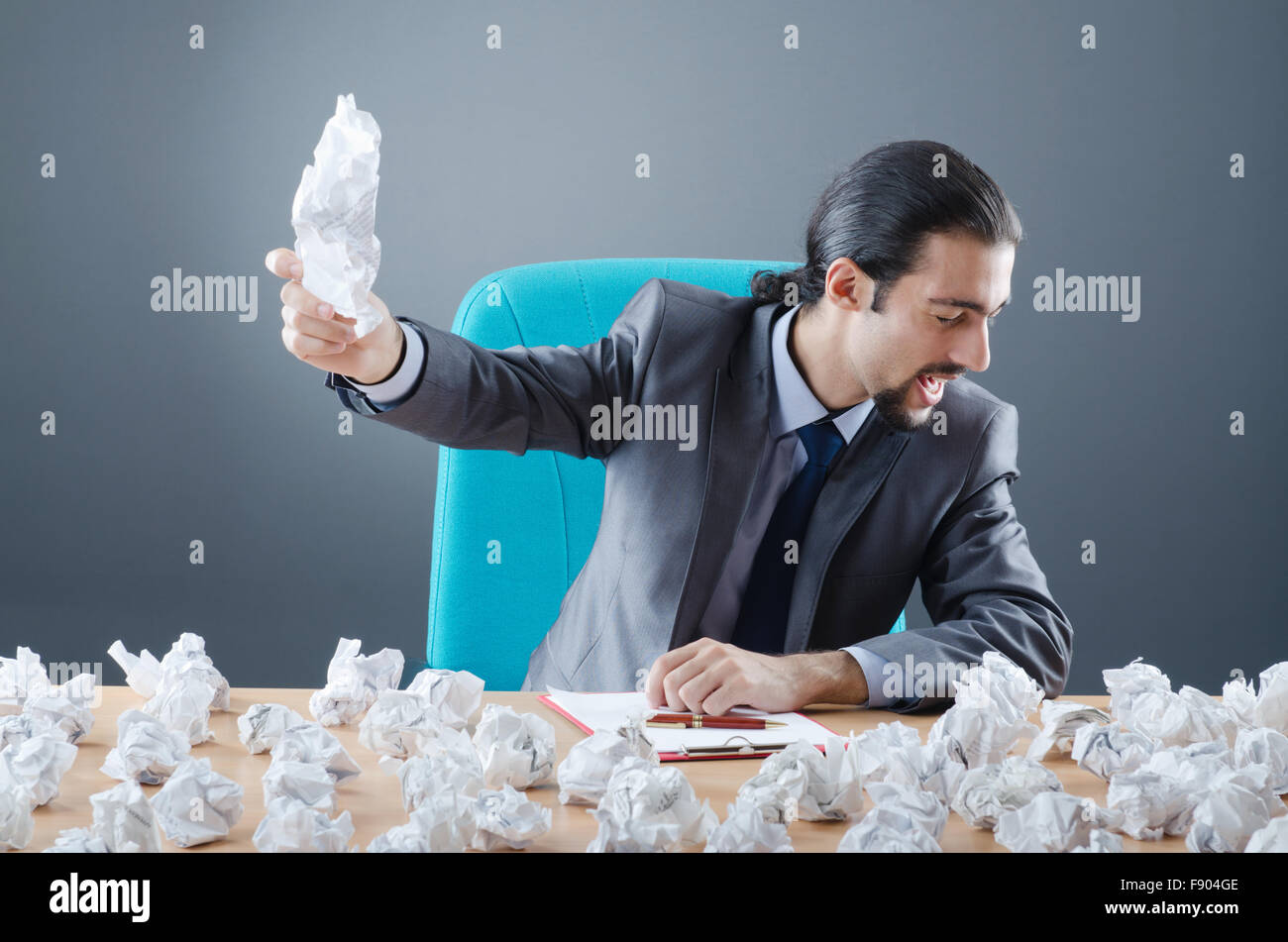 Businessman with lot of discarded paper Stock Photo - Alamy