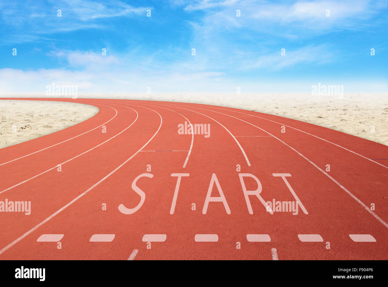 empty outdoor running track with sign start with desert and sky ...