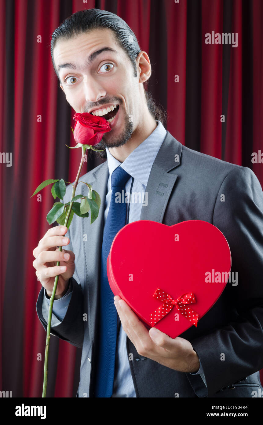 Young man with red rose Stock Photo - Alamy