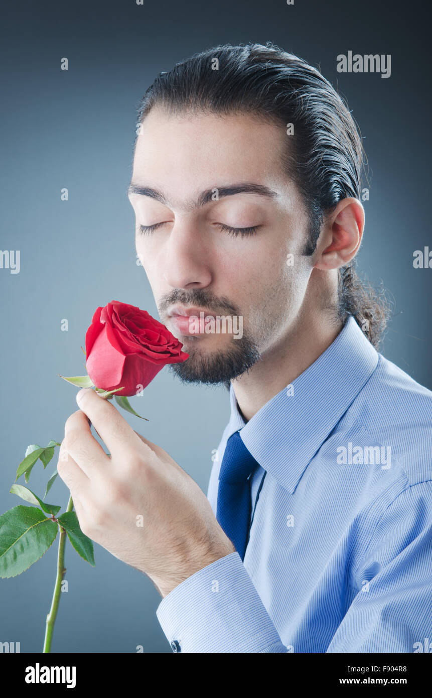 Young man with red rose Stock Photo - Alamy