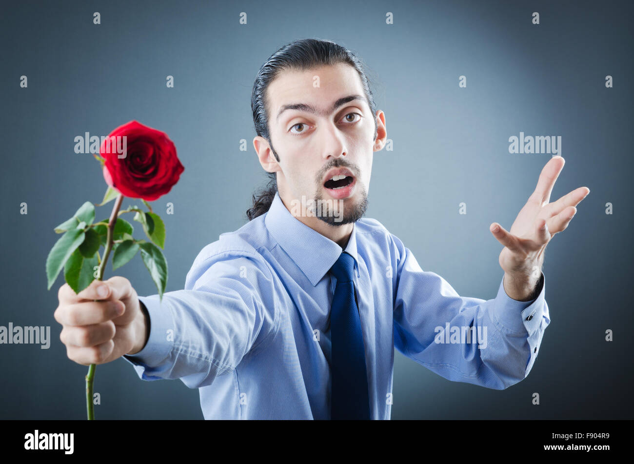 Young man with red rose Stock Photo - Alamy