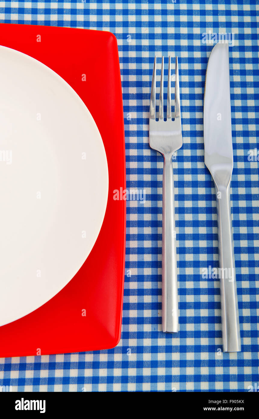Empty plate with utensils Stock Photo - Alamy