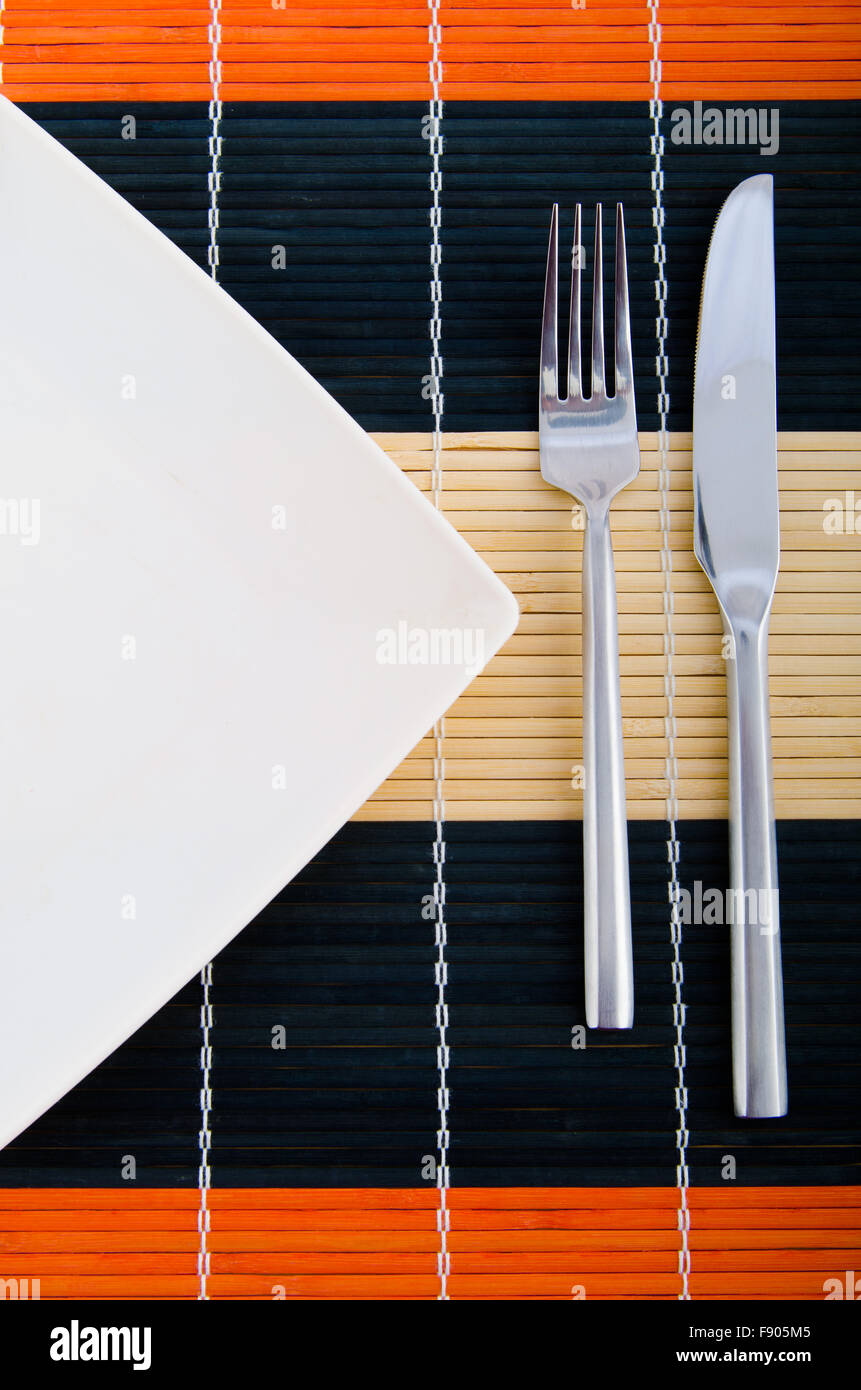 Empty plate with utensils Stock Photo - Alamy