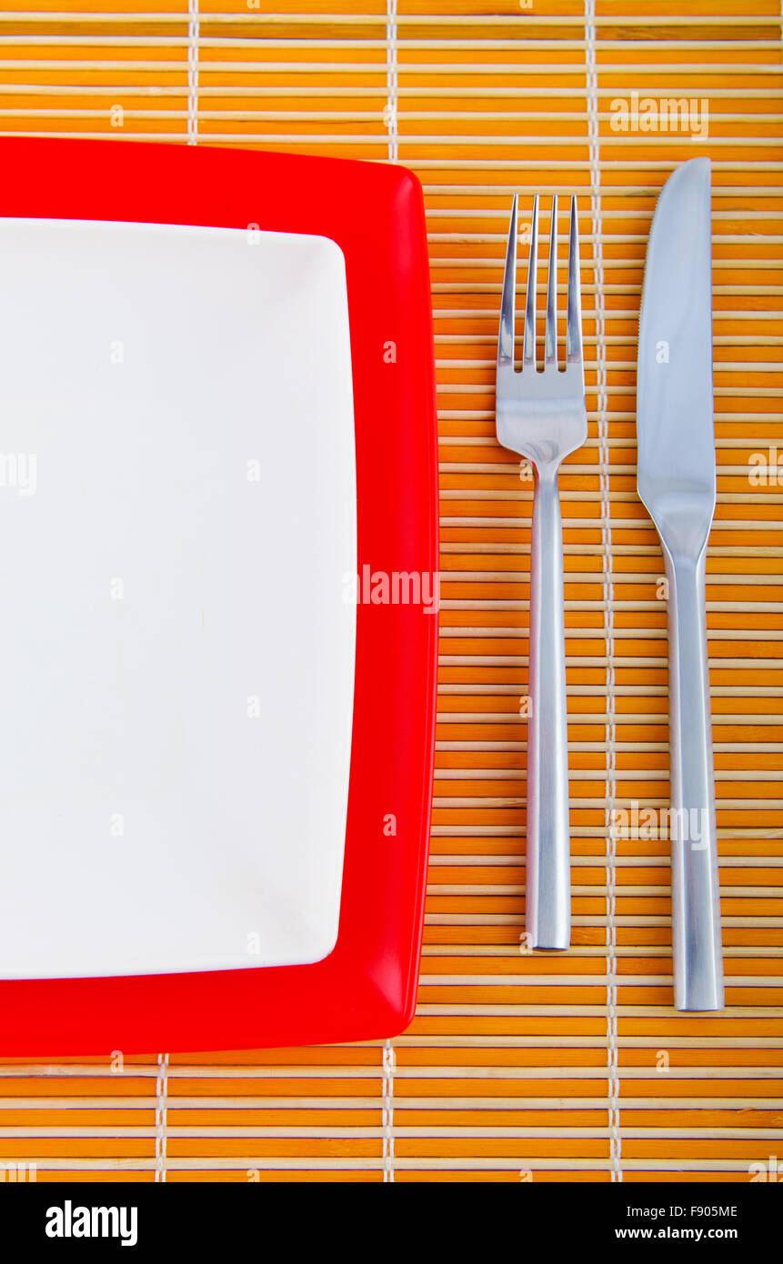 Empty plate with utensils Stock Photo - Alamy