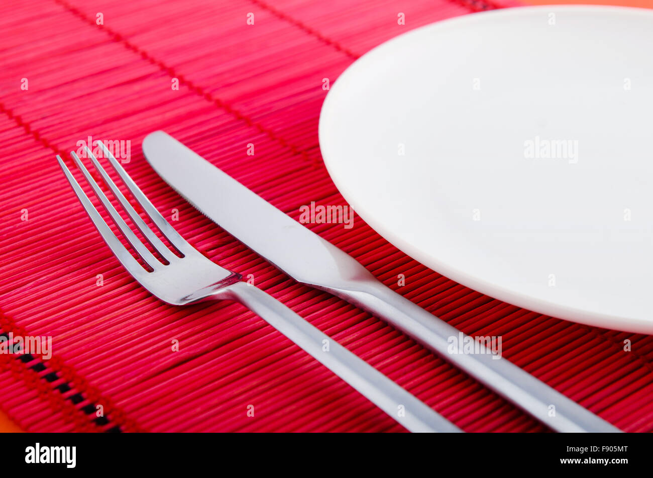 Empty plate with utensils Stock Photo - Alamy