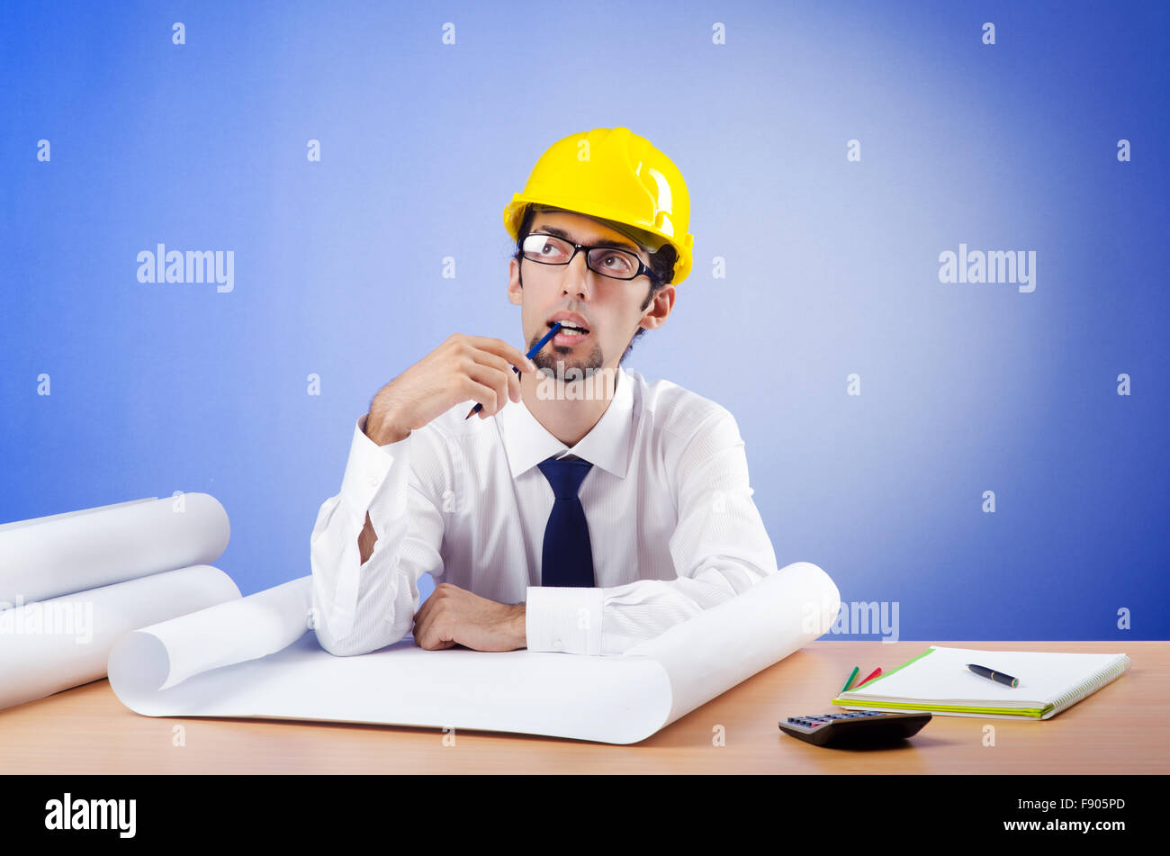 Young engineer looking at drawings Stock Photo - Alamy