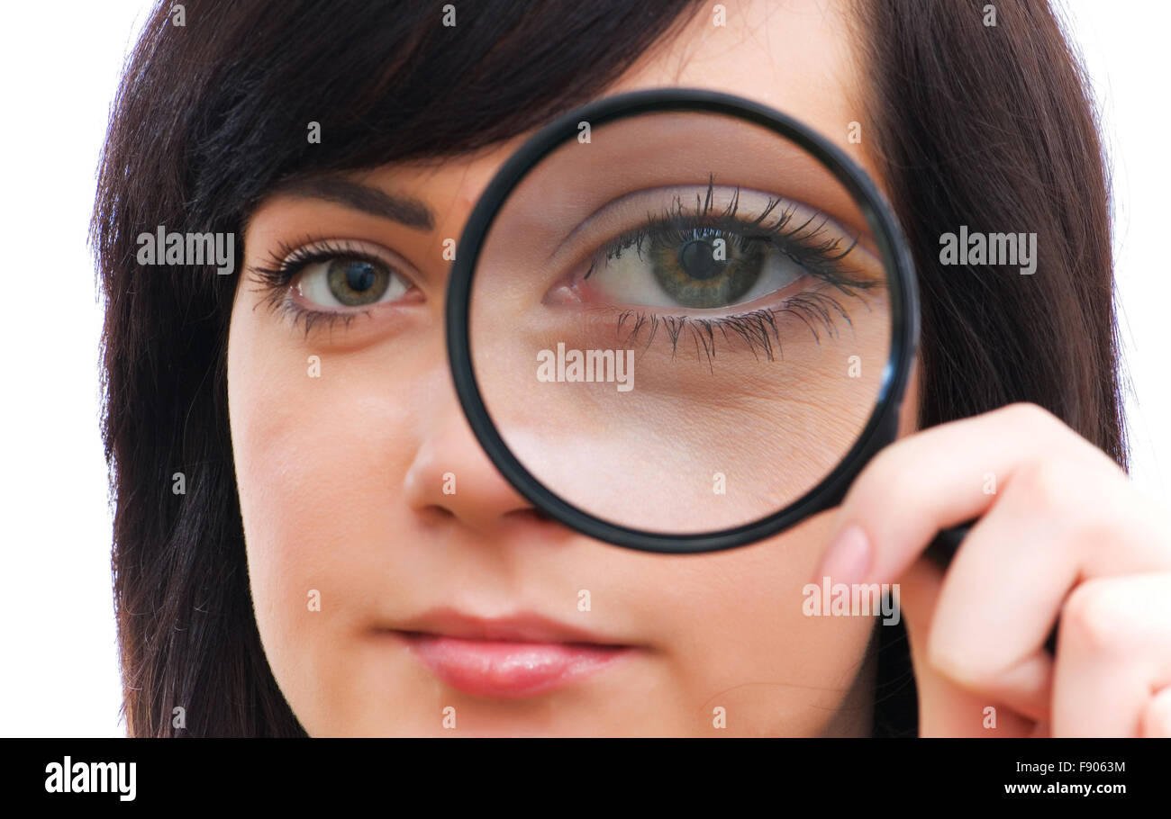 Girl's eye magnified through magnified glass on white Stock Photo - Alamy