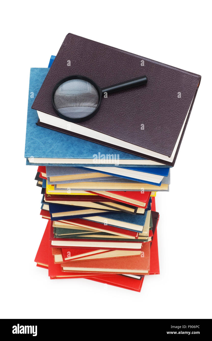 Magnifying glass over the stack of books Stock Photo - Alamy