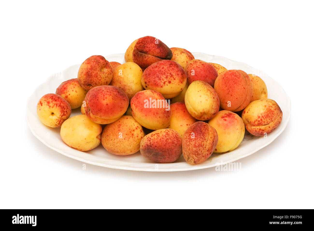 Many colourful red apricots in the plate Stock Photo - Alamy