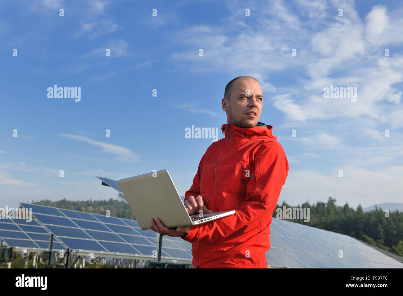 business man engineer using laptop at solar panels plant eco energy ...