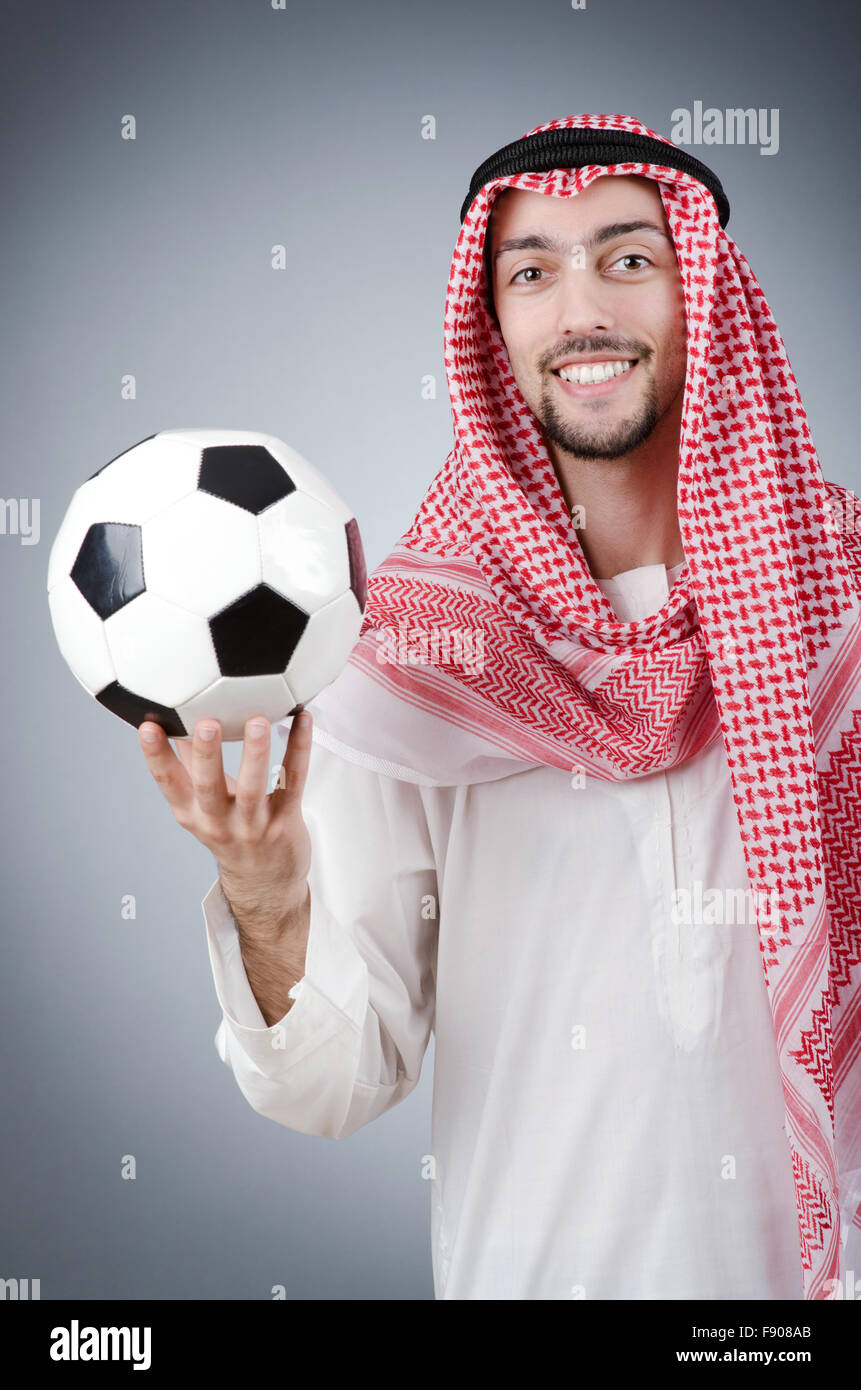 Arab with football in studio shooting Stock Photo - Alamy