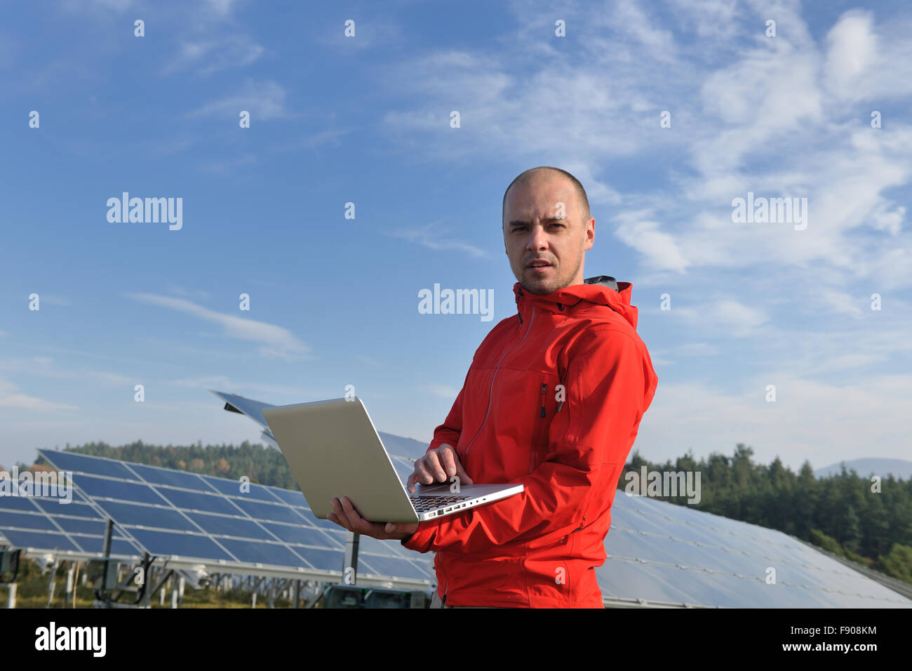 business man engineer using laptop at solar panels plant eco energy ...
