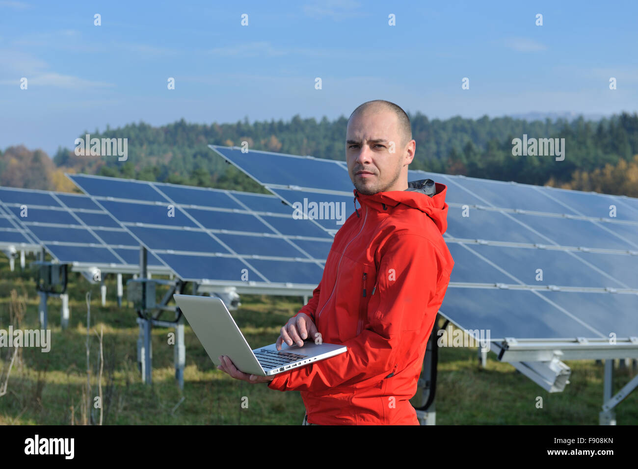 business man engineer using laptop at solar panels plant eco energy ...