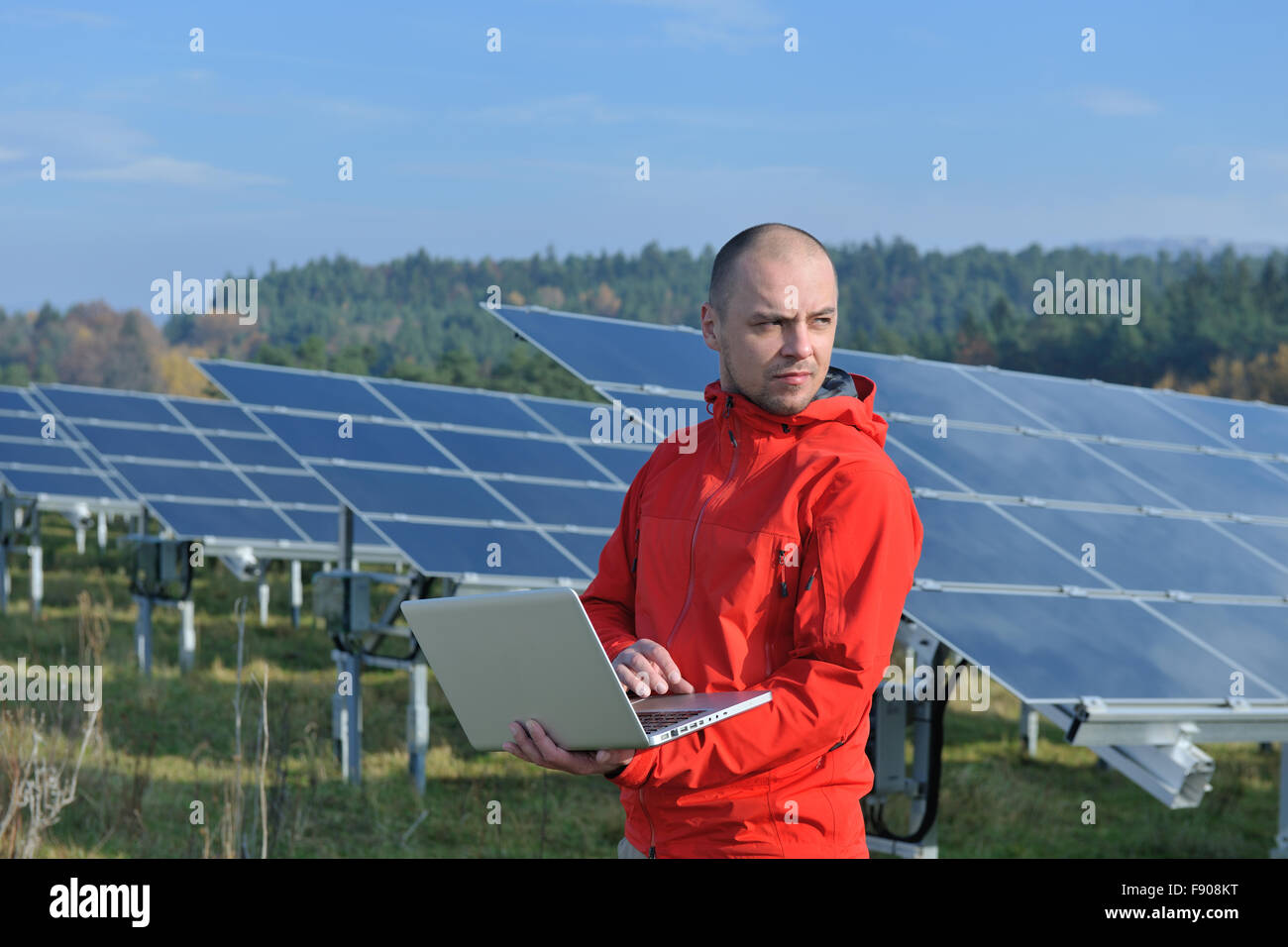 business man engineer using laptop at solar panels plant eco energy ...