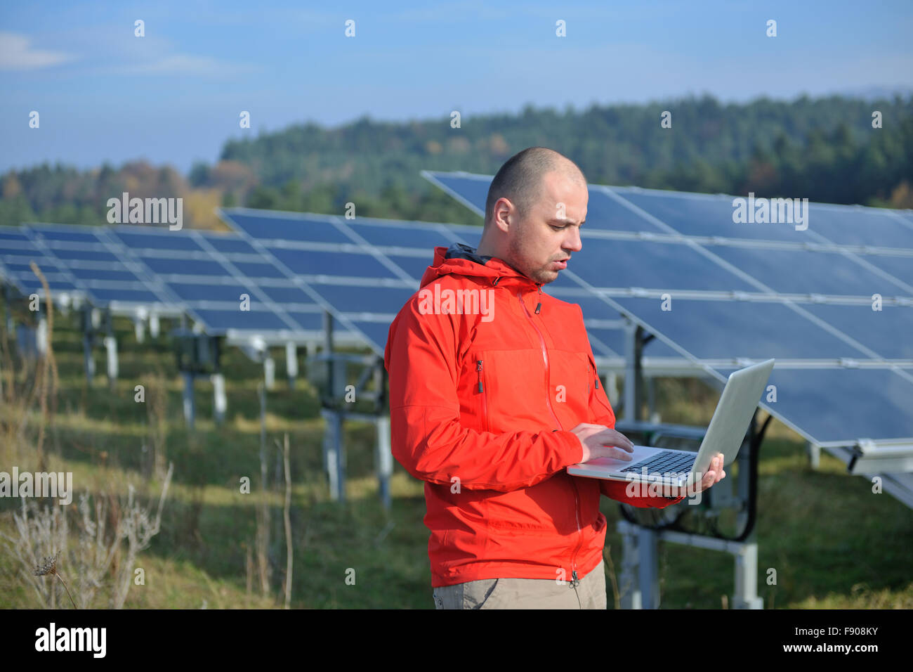 business man engineer using laptop at solar panels plant eco energy ...