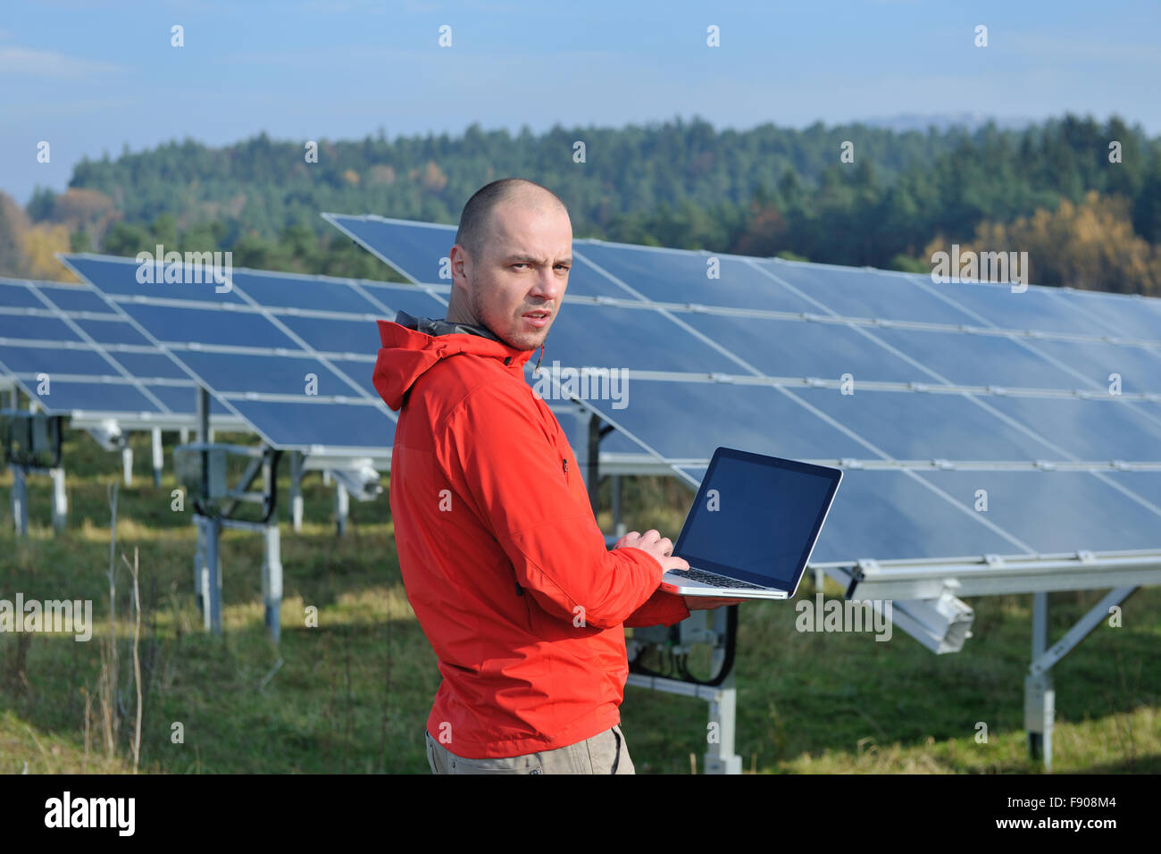 business man engineer using laptop at solar panels plant eco energy ...