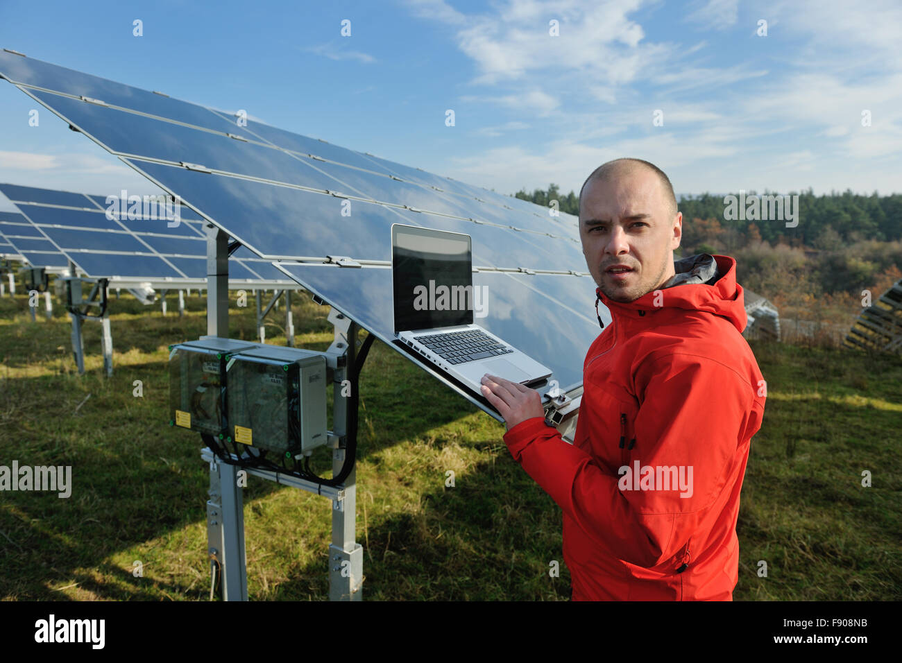 business man engineer using laptop at solar panels plant eco energy ...