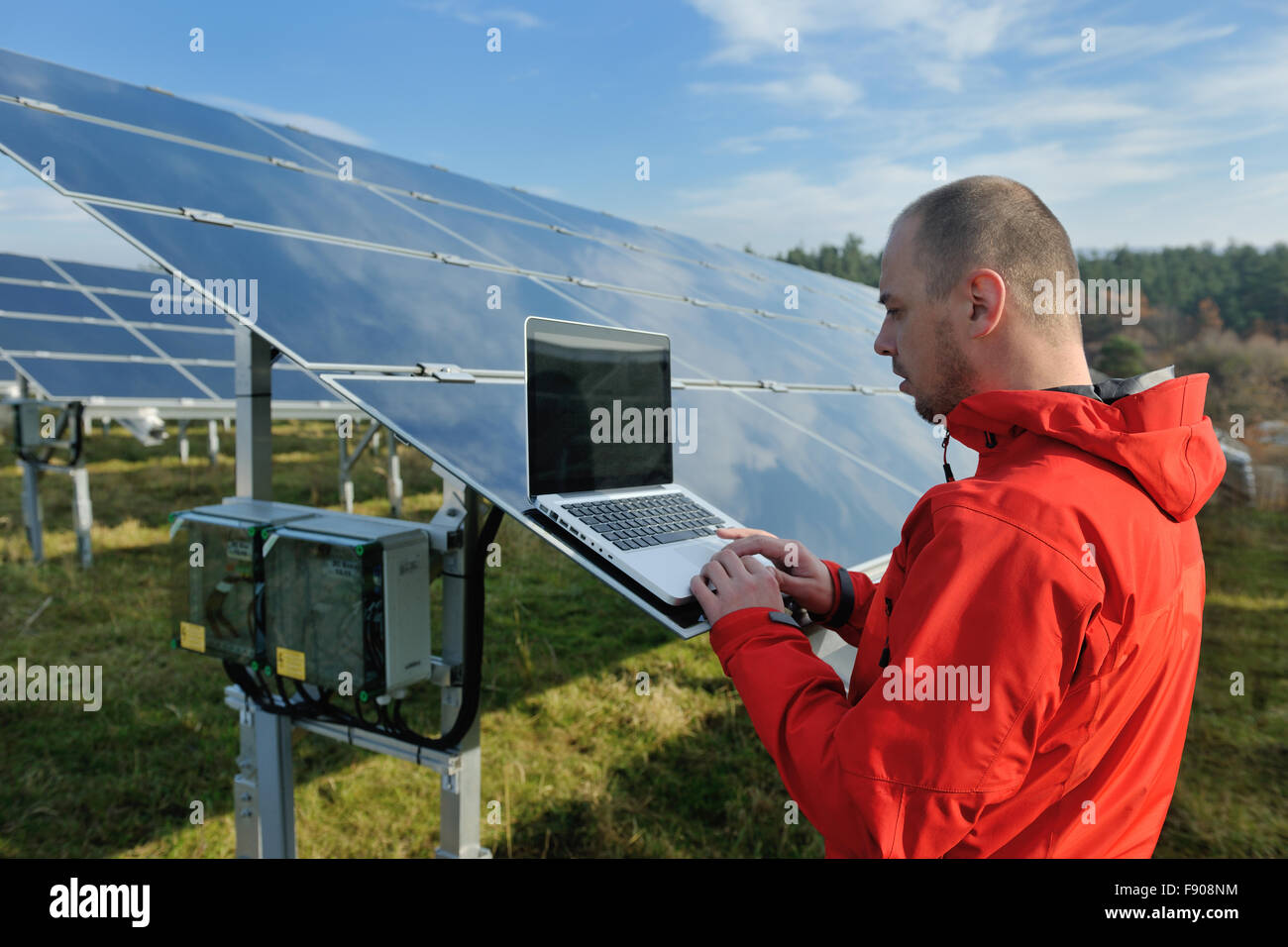 business man engineer using laptop at solar panels plant eco energy ...