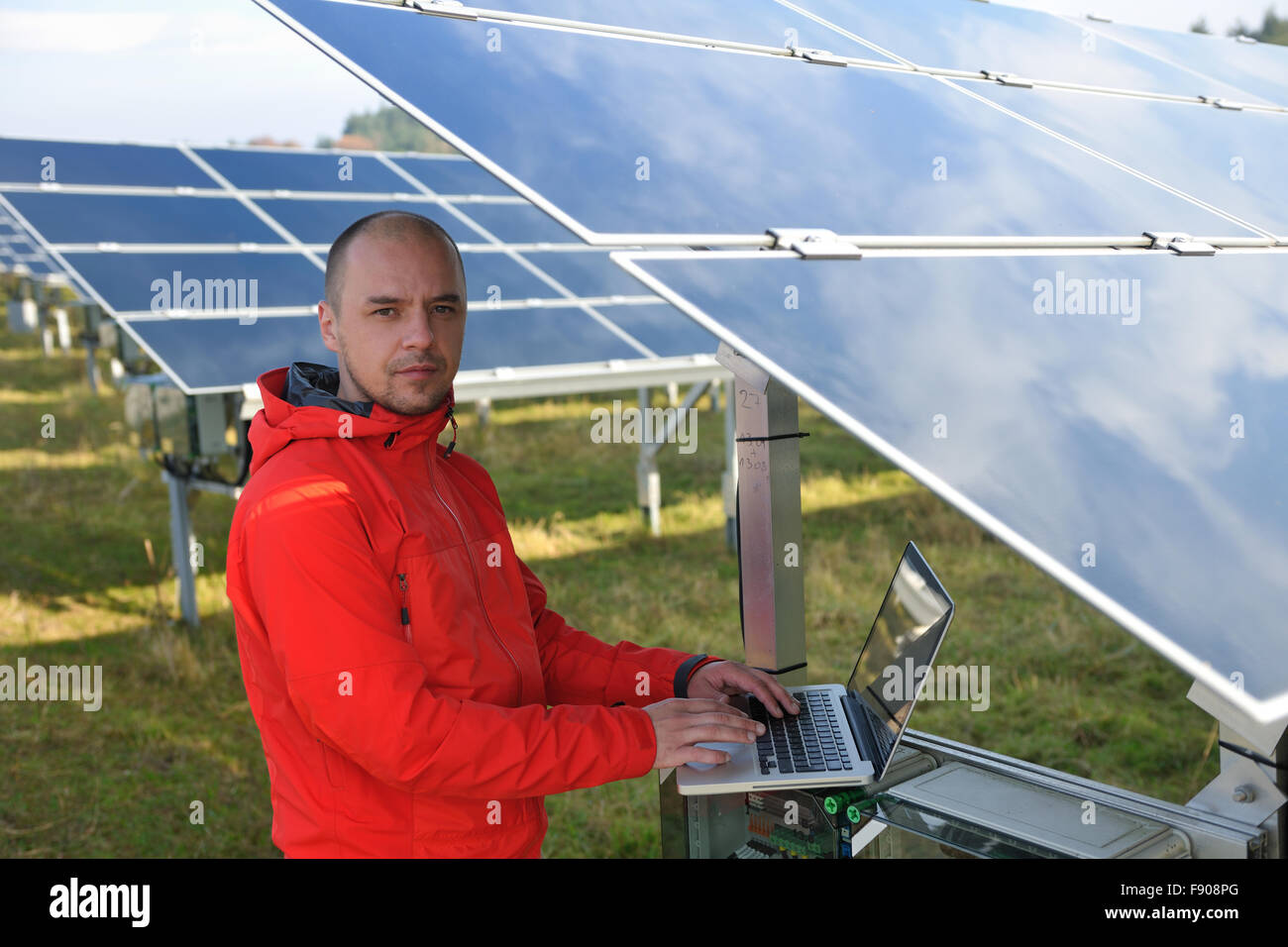 business man engineer using laptop at solar panels plant eco energy ...