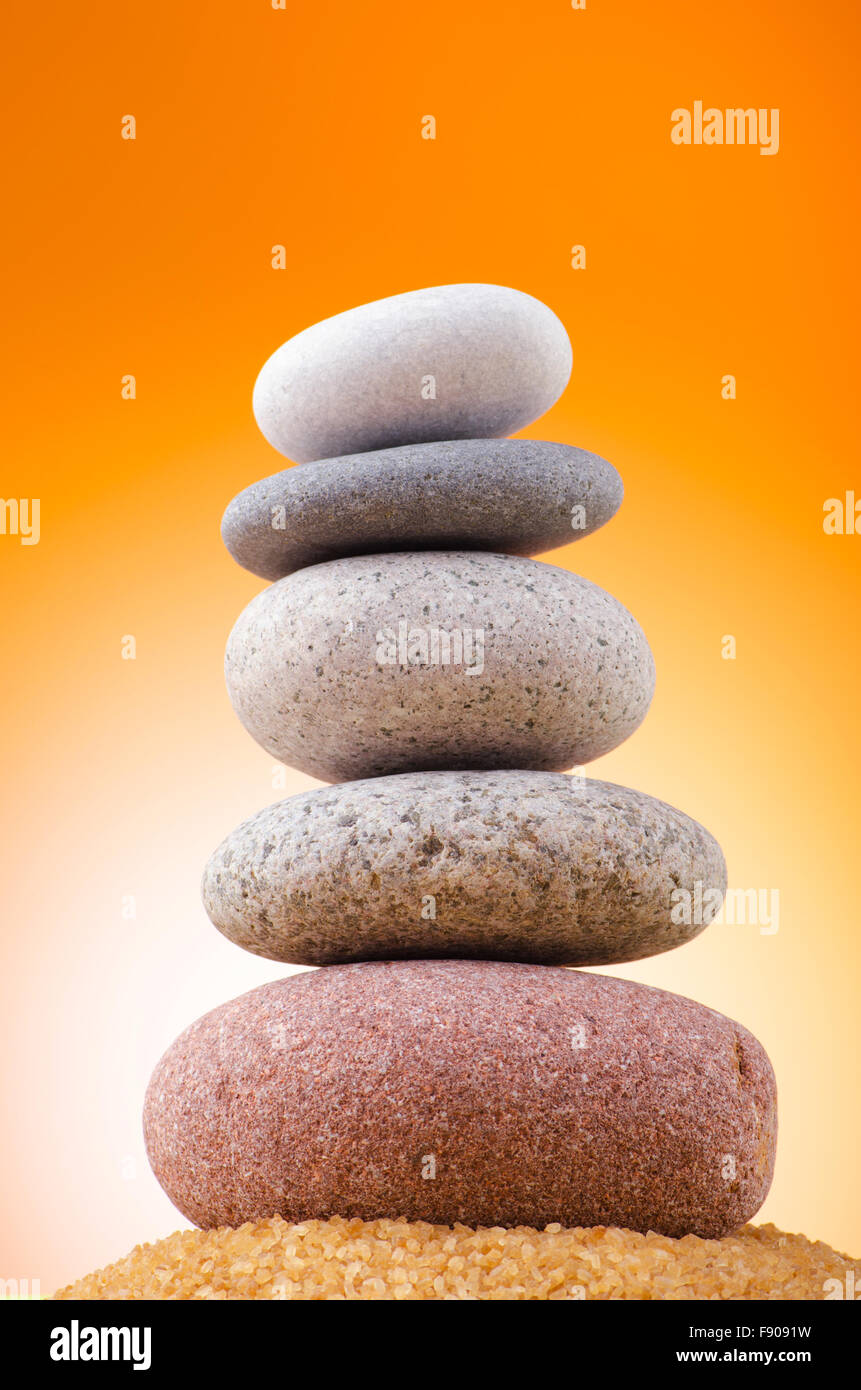 Balanced pebbles with colour background Stock Photo - Alamy