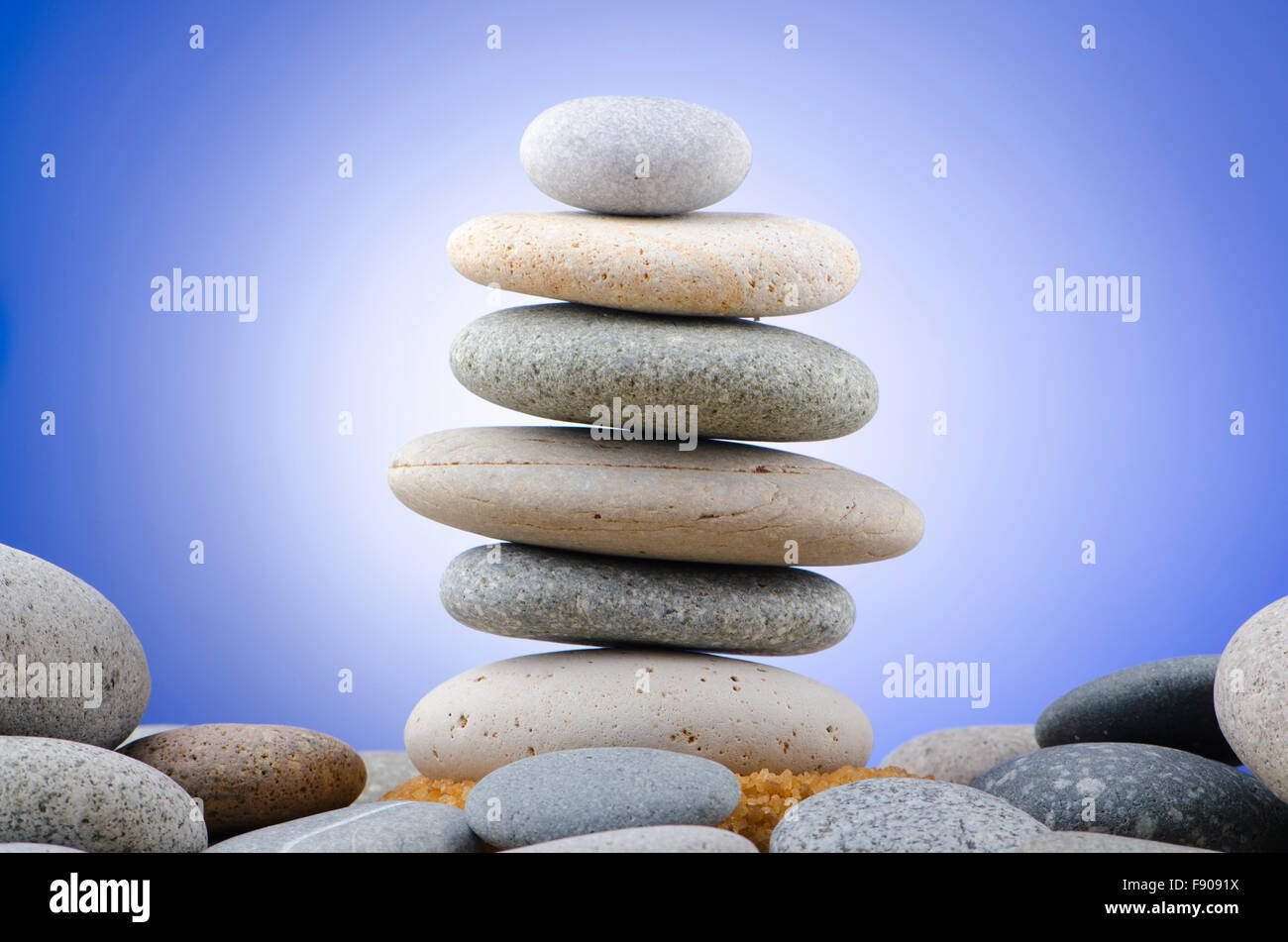 Balanced pebbles with colour background Stock Photo - Alamy