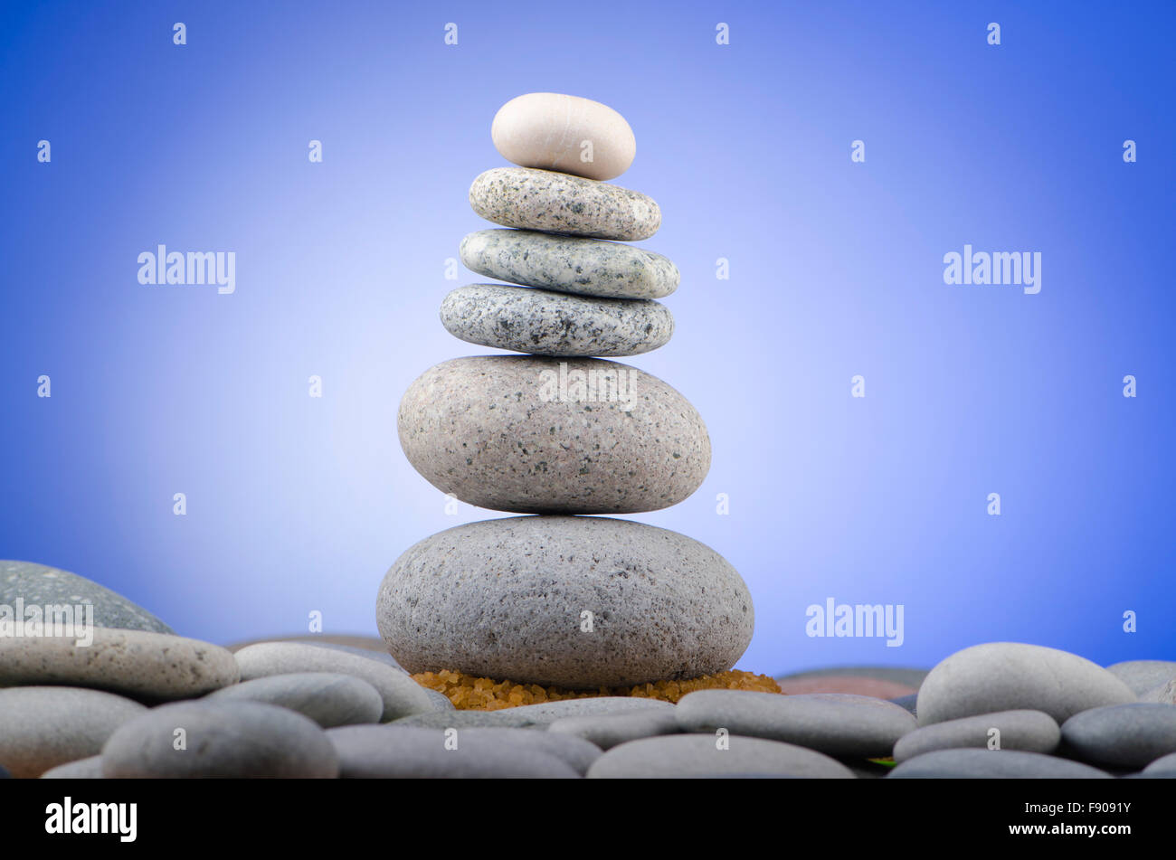 Balanced pebbles with colour background Stock Photo - Alamy