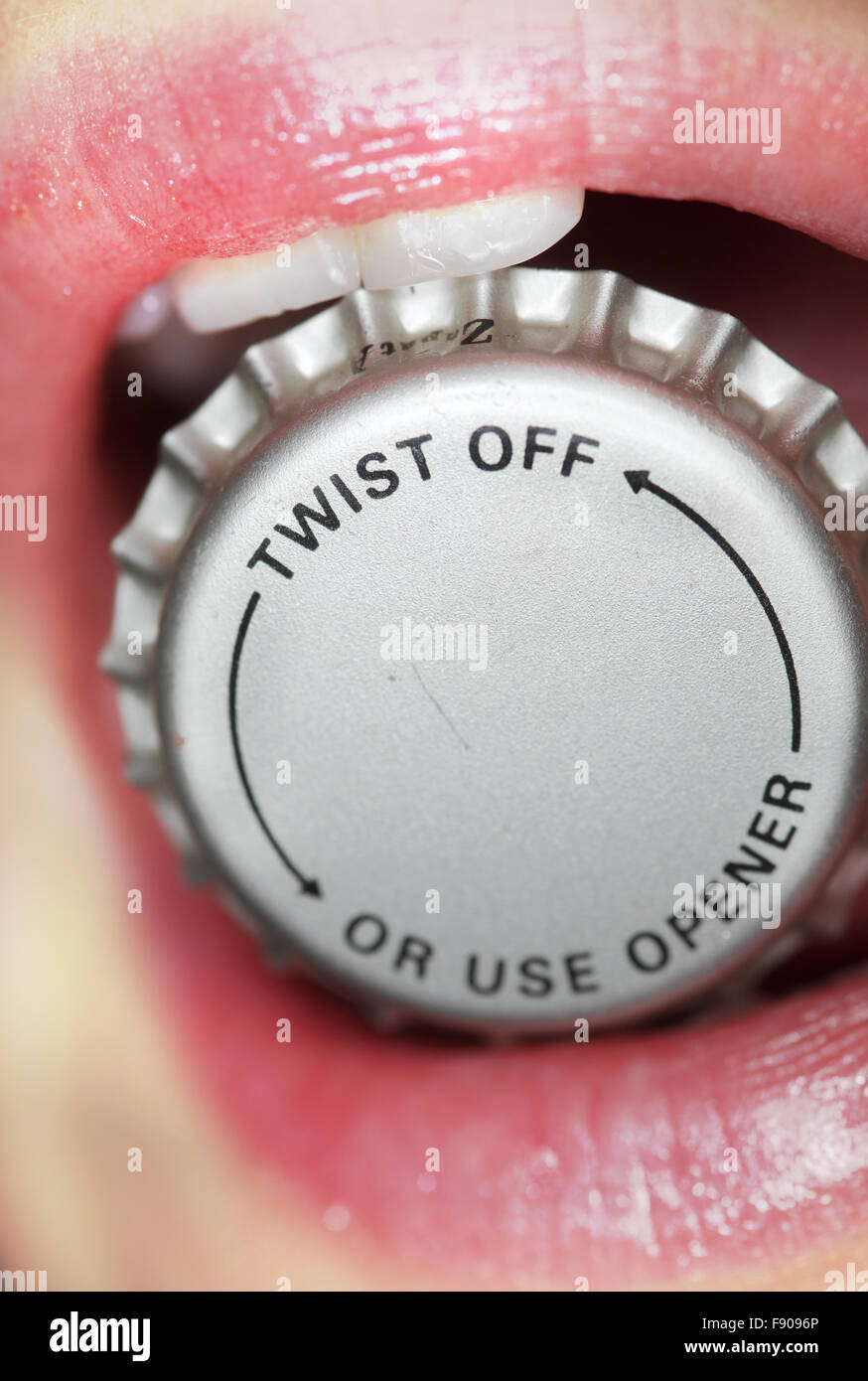 twist off beer cap in womans mouth Stock Photo - Alamy
