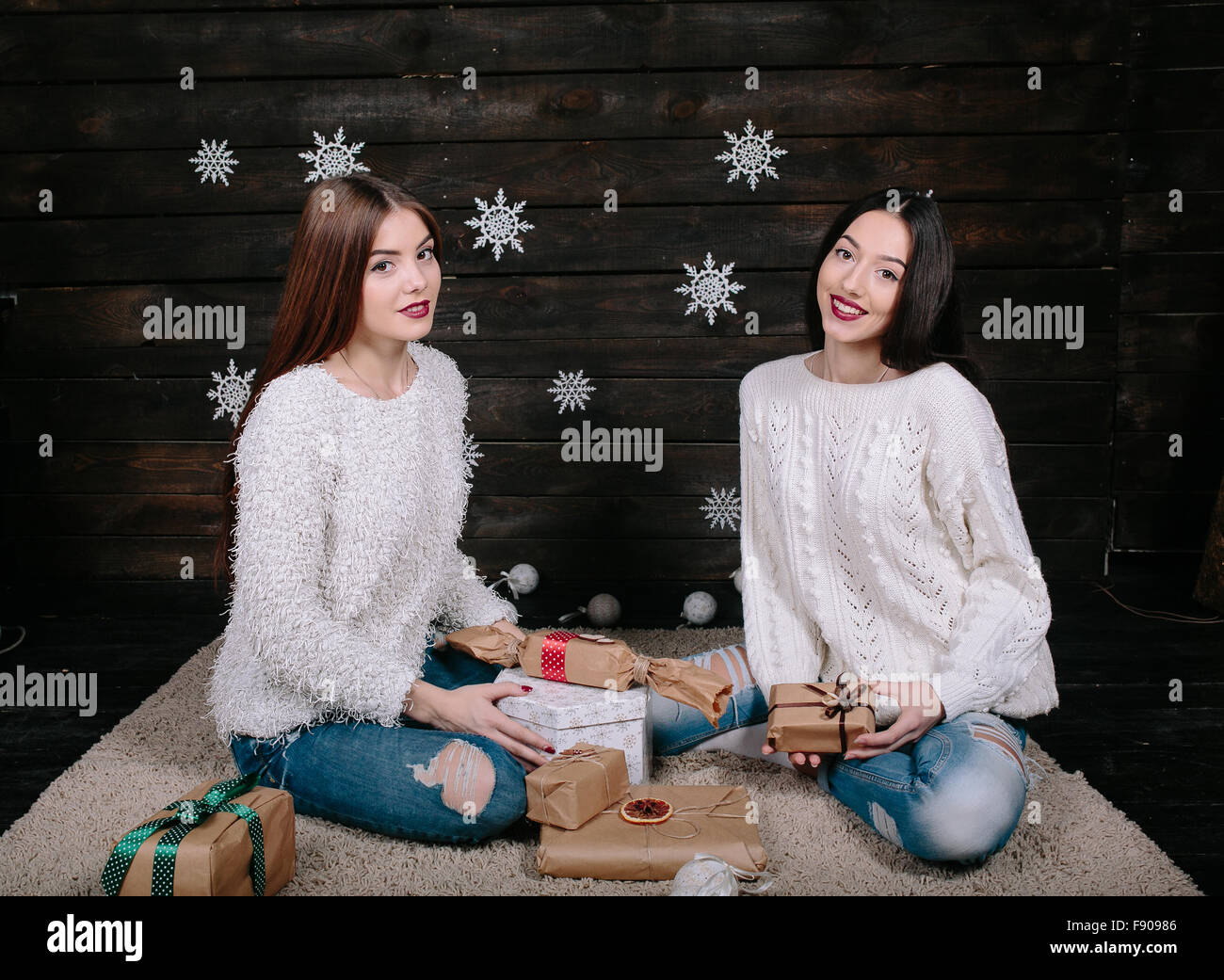 Two pretty girls with gifts for Christmas Stock Photo - Alamy