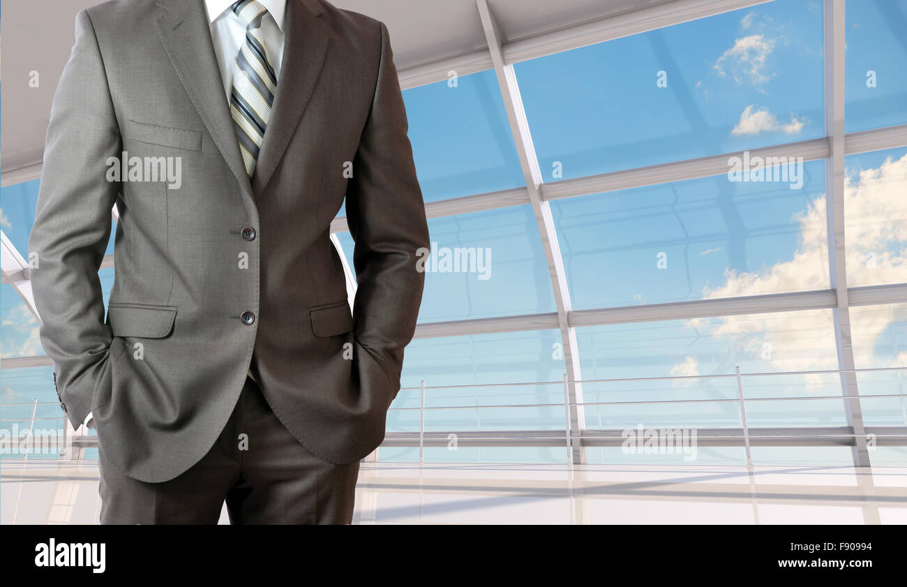 Businessman standing by window Stock Photo - Alamy