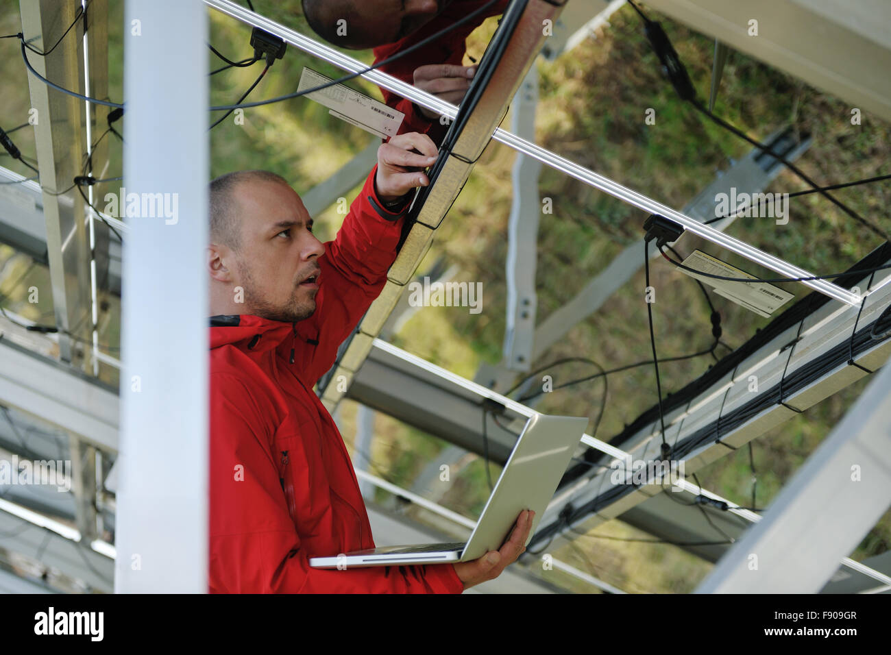 business man engineer using laptop at solar panels plant eco energy ...