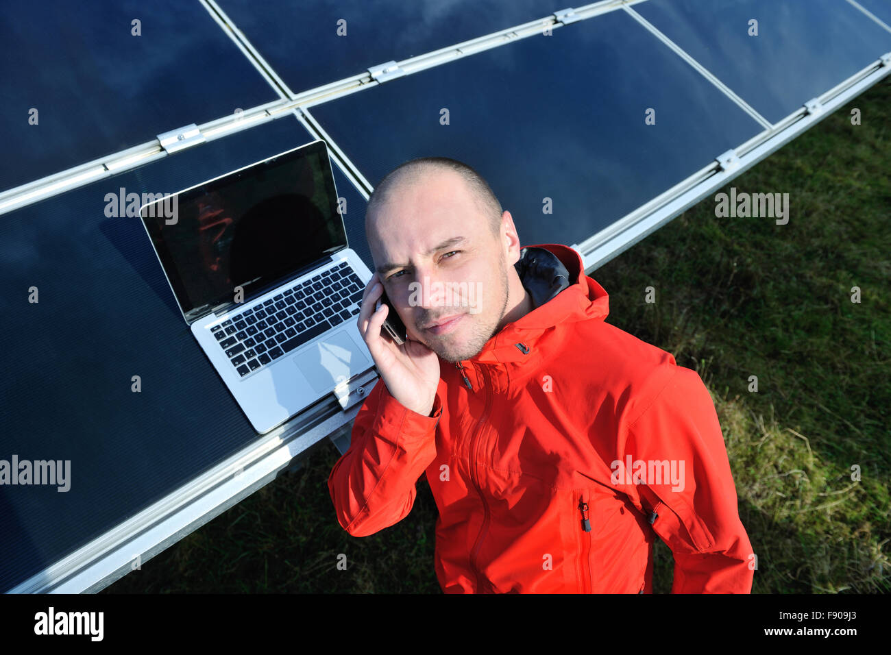 business man engineer using laptop at solar panels plant eco energy ...