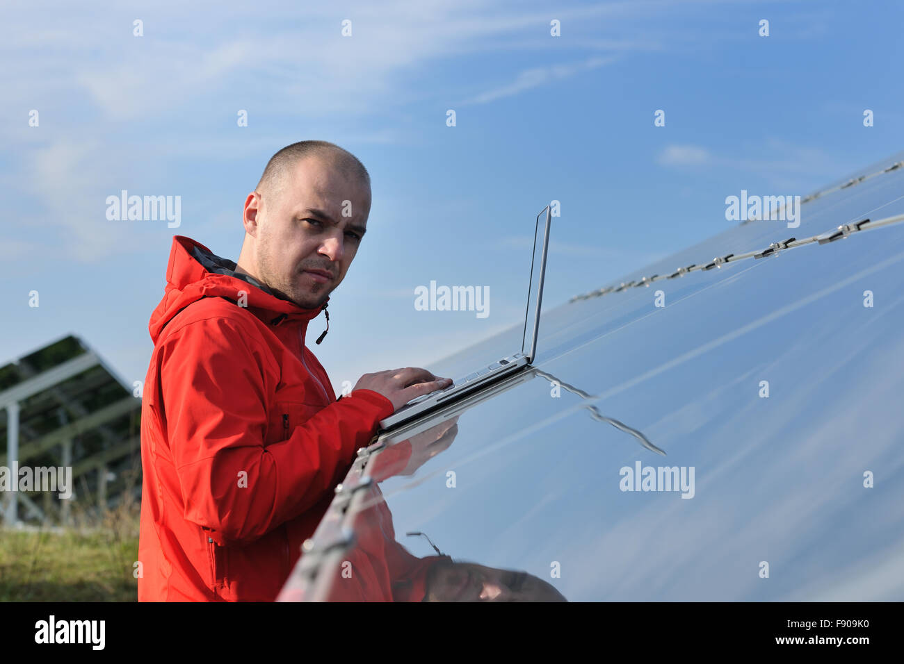 business man engineer using laptop at solar panels plant eco energy ...