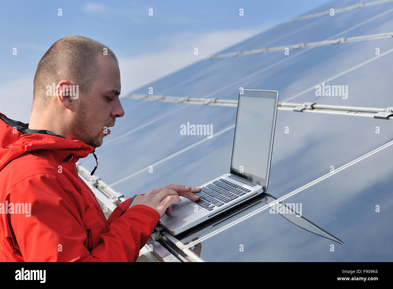 business man engineer using laptop at solar panels plant eco energy ...