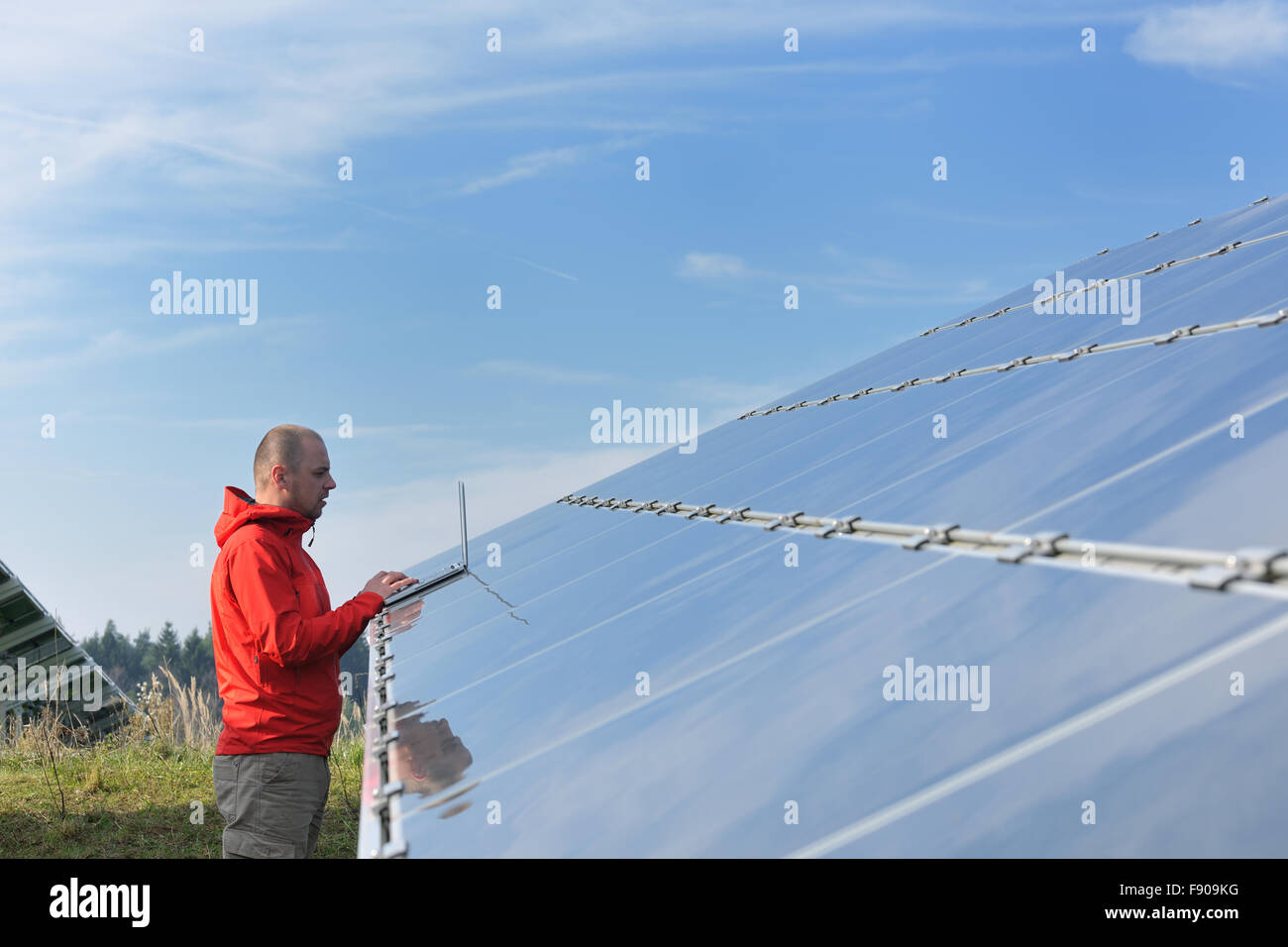 business man engineer using laptop at solar panels plant eco energy ...