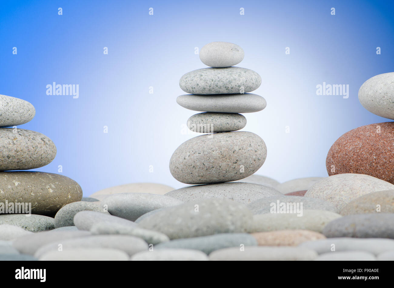 Pebbles stack against gradient background Stock Photo - Alamy
