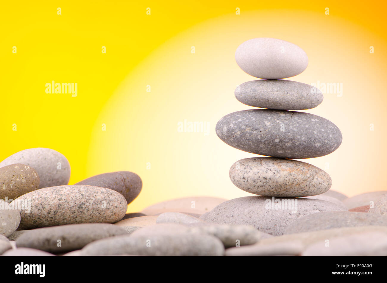 Pebbles stack against gradient background Stock Photo - Alamy