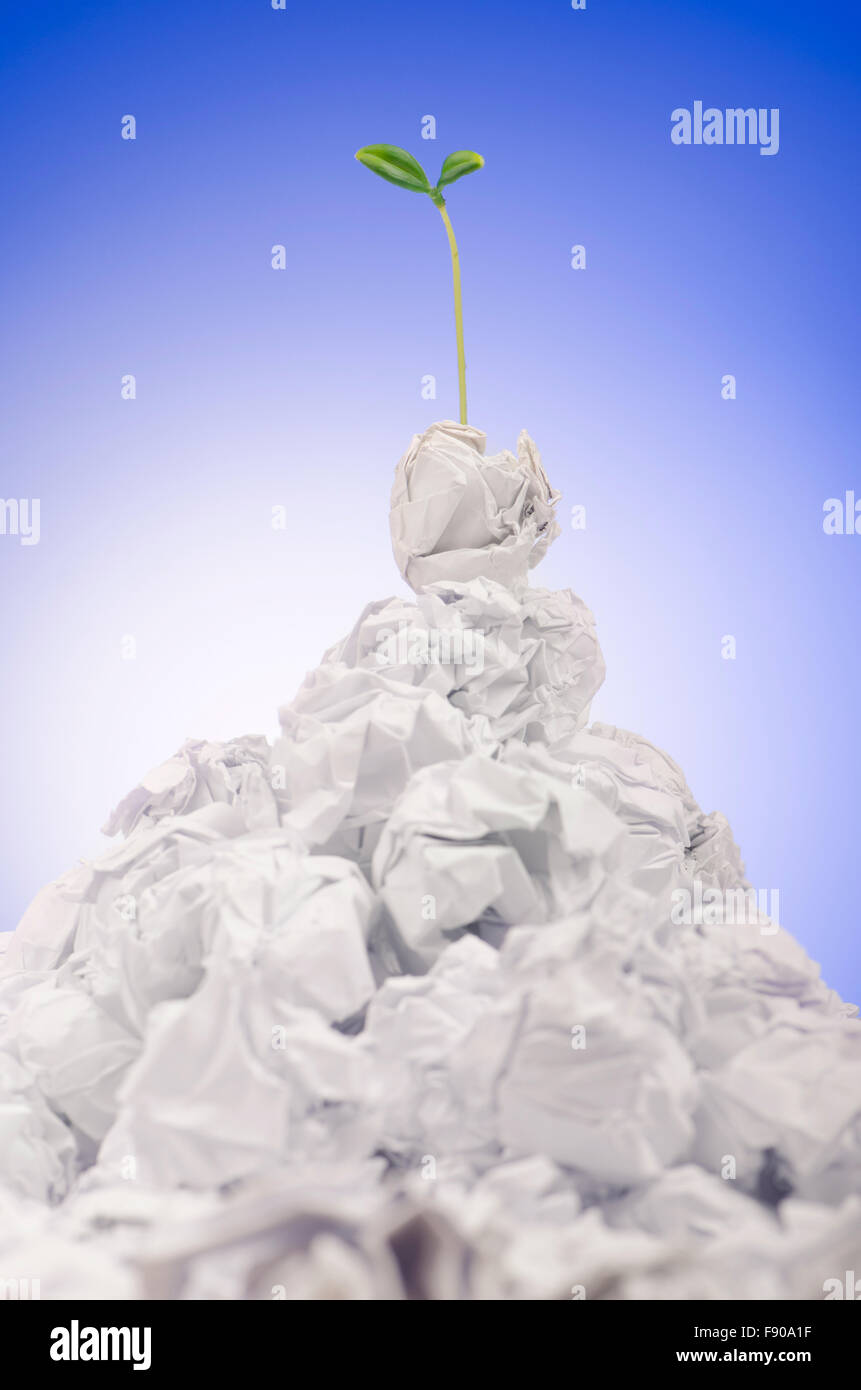 Green seedlings growing out of paper Stock Photo - Alamy