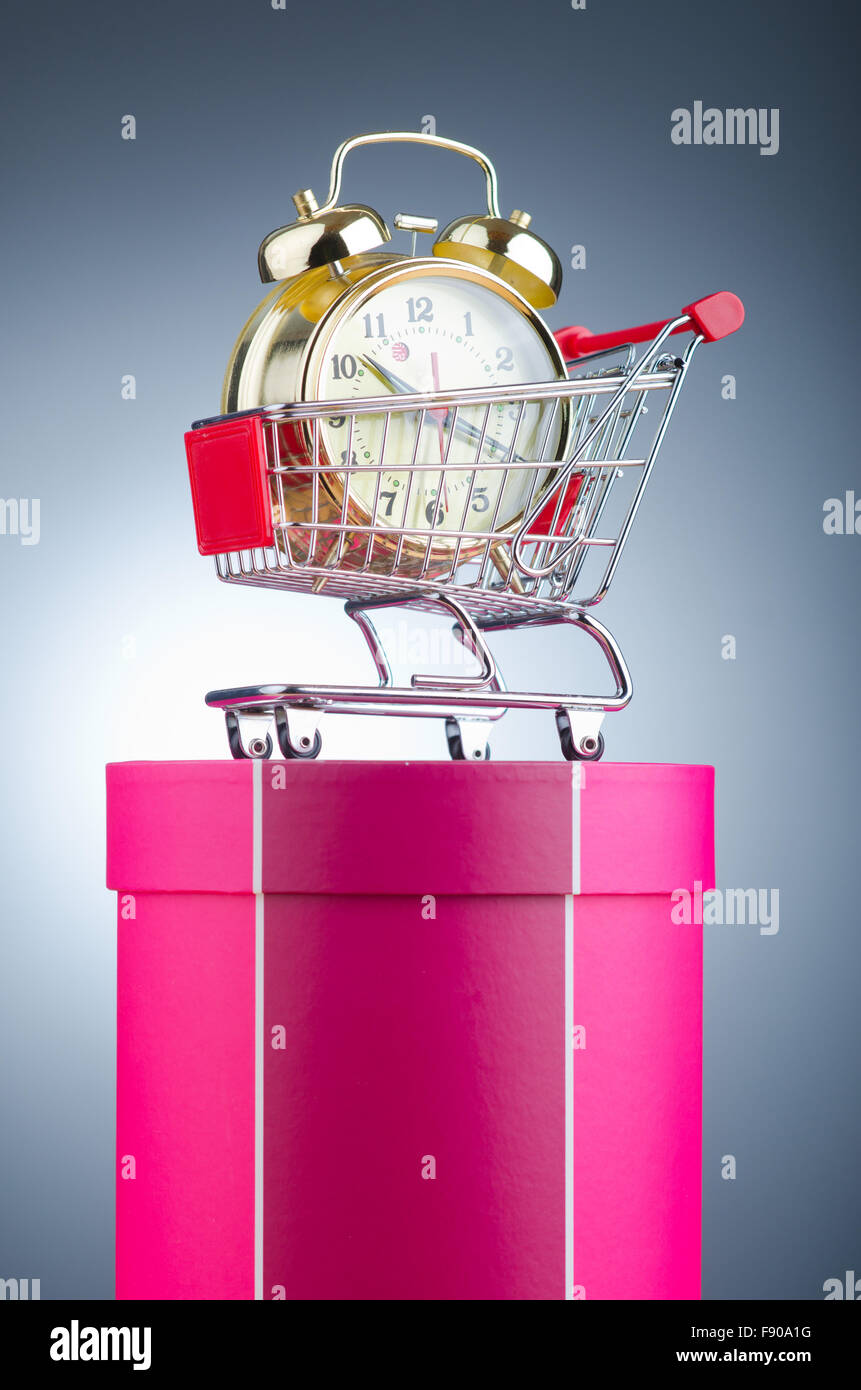 Buying time concept with clock and shopping cart Stock Photo - Alamy