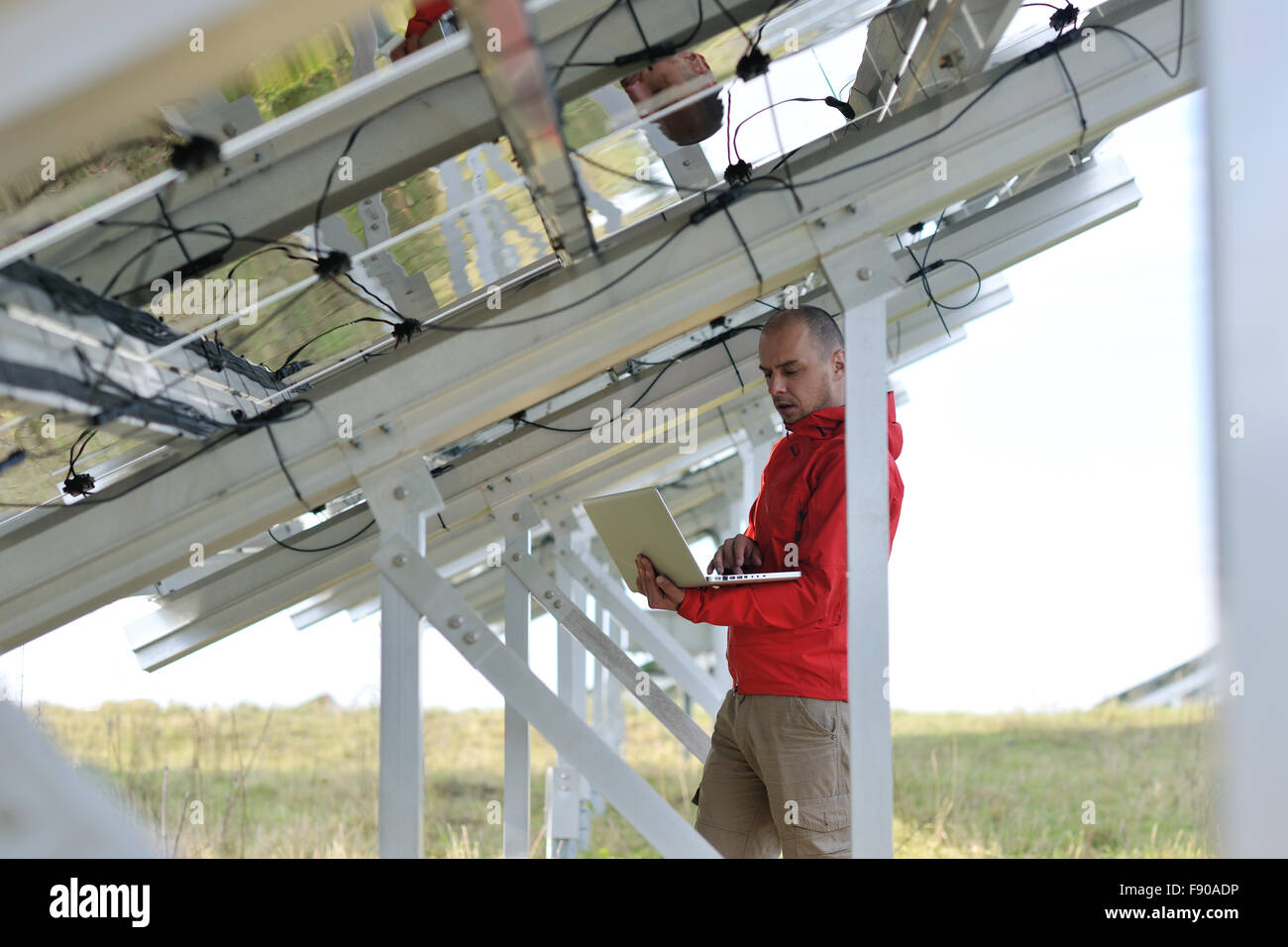business man engineer using laptop at solar panels plant eco energy ...