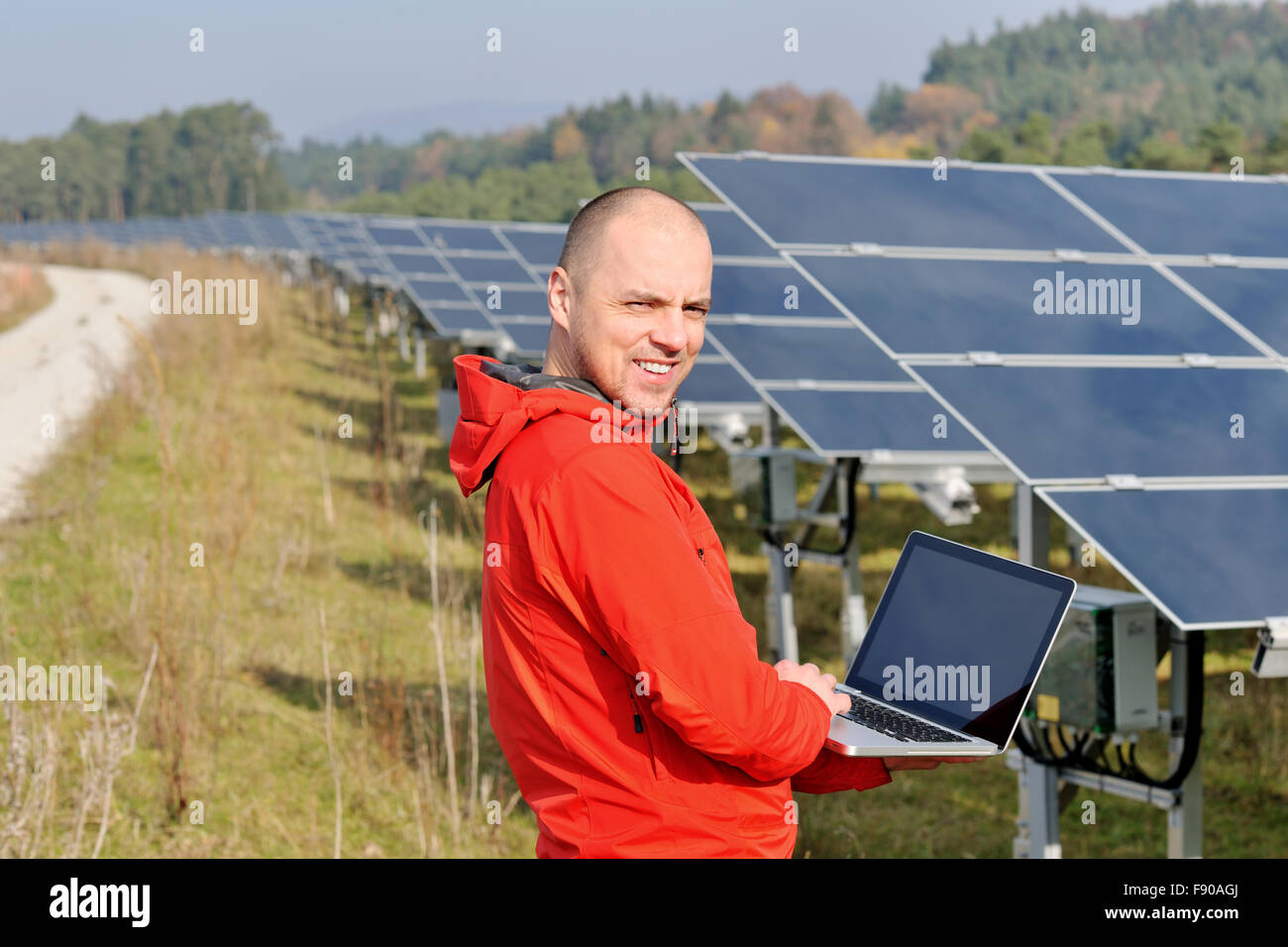 business man engineer using laptop at solar panels plant eco energy ...