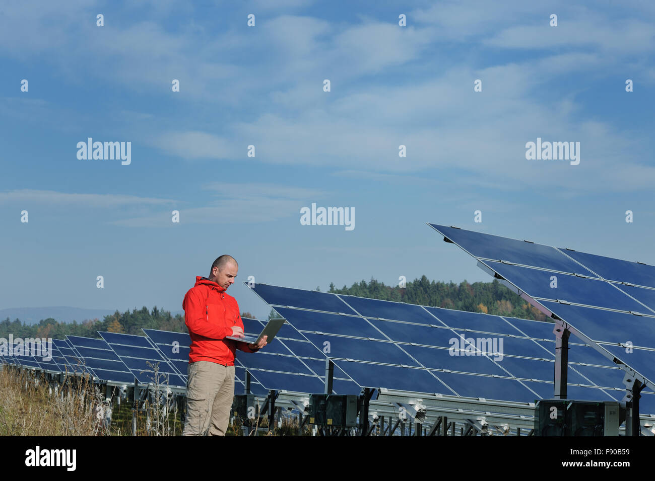 business man engineer using laptop at solar panels plant eco energy ...