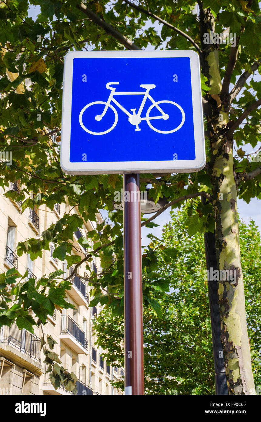 Bicycle sign on blue background Stock Photo - Alamy