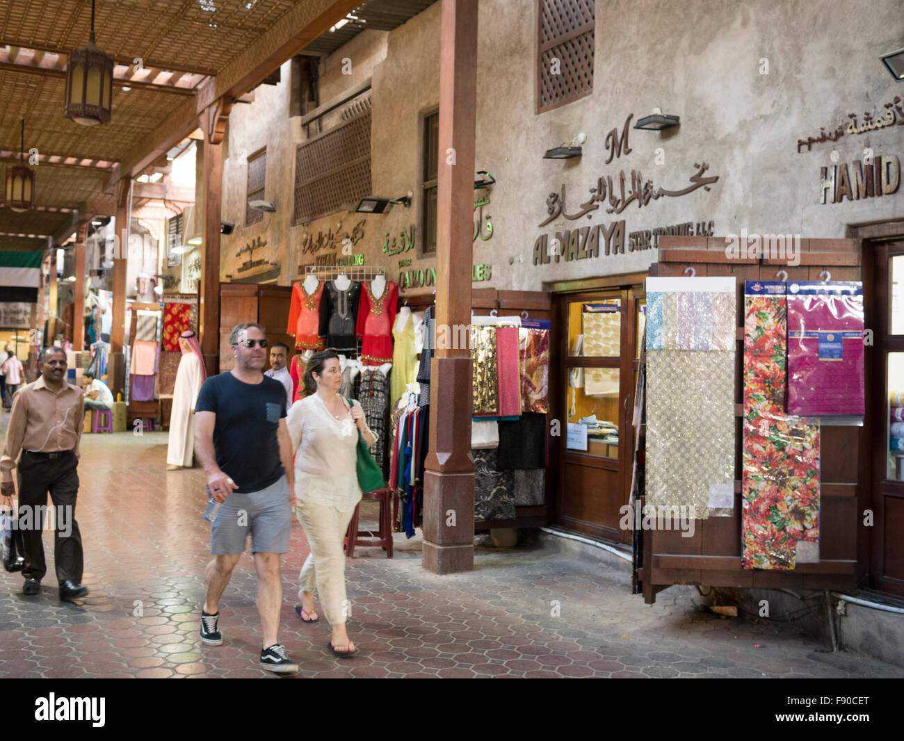 Tourists shopping in textile market (souk) in Dubai heritage are ...