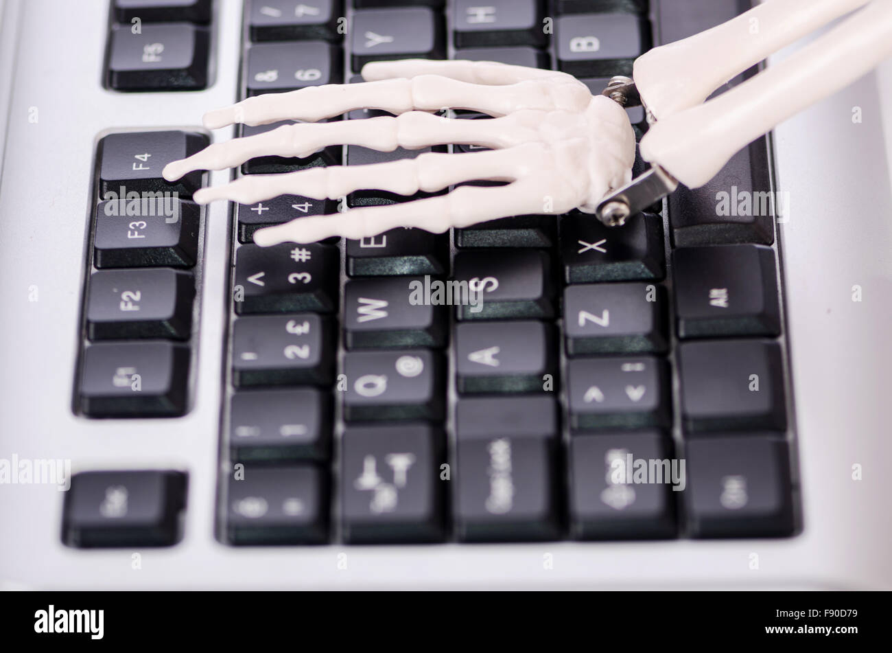 Skeleton working on the keyboard Stock Photo - Alamy