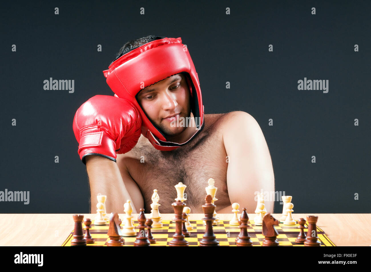 Boxer stuggling with chess game Stock Photo - Alamy