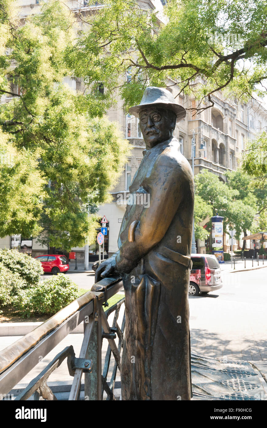 A sculpture of Imre Nagy, a man on a small bridge facing the Parliament ...