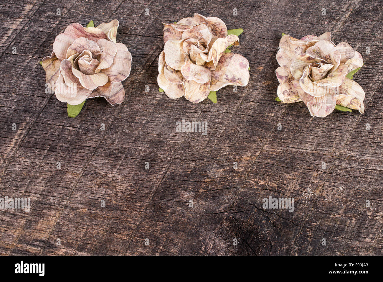 Handmade paper flowers line the top of barn wood Stock Photo - Alamy