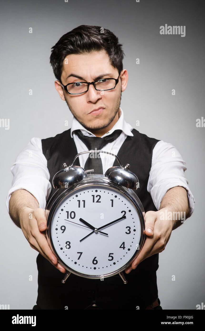 Businessman with clock in time concept Stock Photo - Alamy