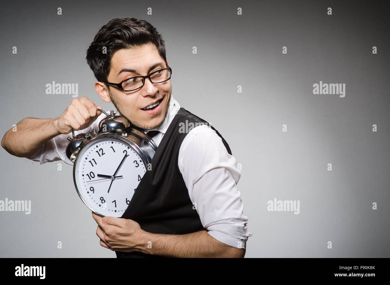 Businessman with clock in time concept Stock Photo - Alamy