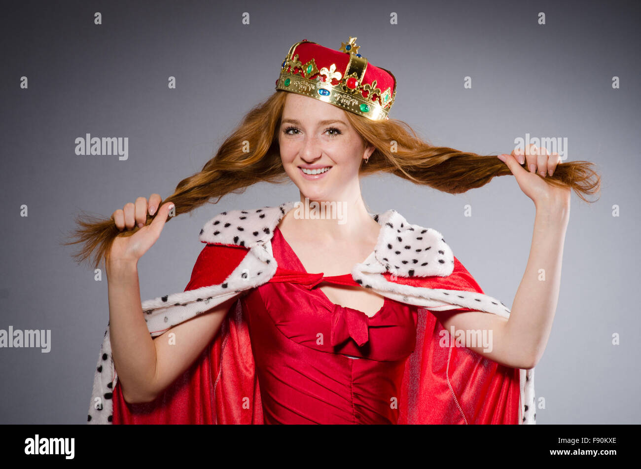 Queen in red dress in studio Stock Photo - Alamy